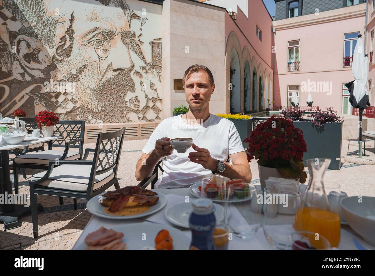 Man Enjoying Breakfast at Outdoor Dining Area of Luxury Hotel with ...