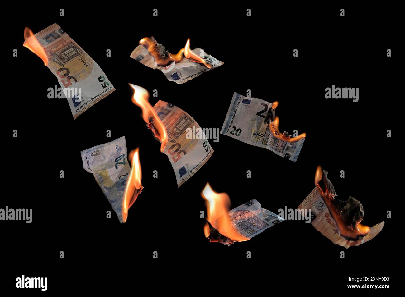 Burning money, twenty and fifty euro banknotes with flames flying ...