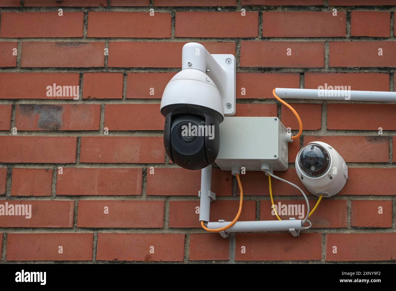 Surveillance camera system on a red brick wall, modern security ...