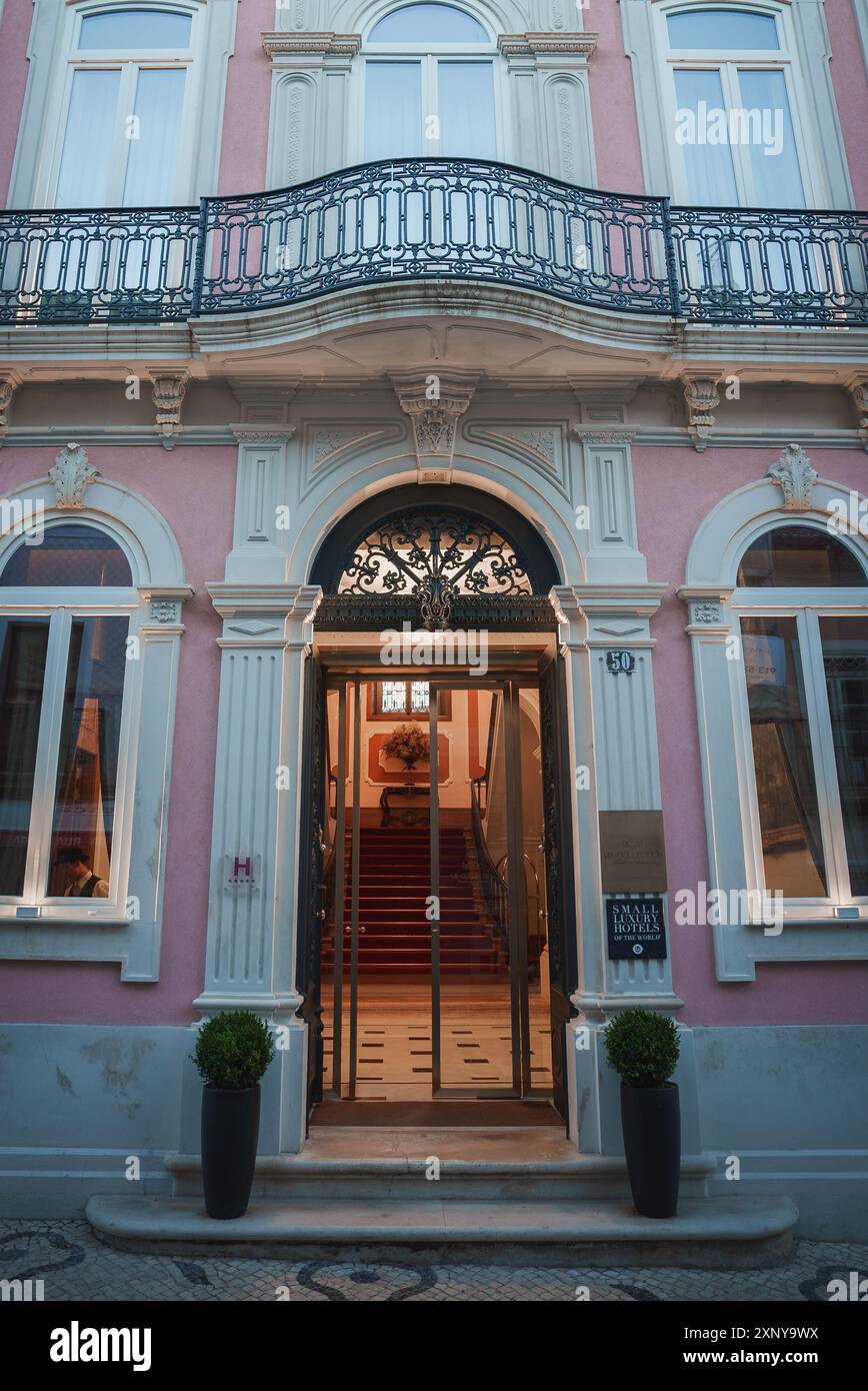 Elegant Entrance of Luxury Hotel with Pink Facade and Grand Archway ...