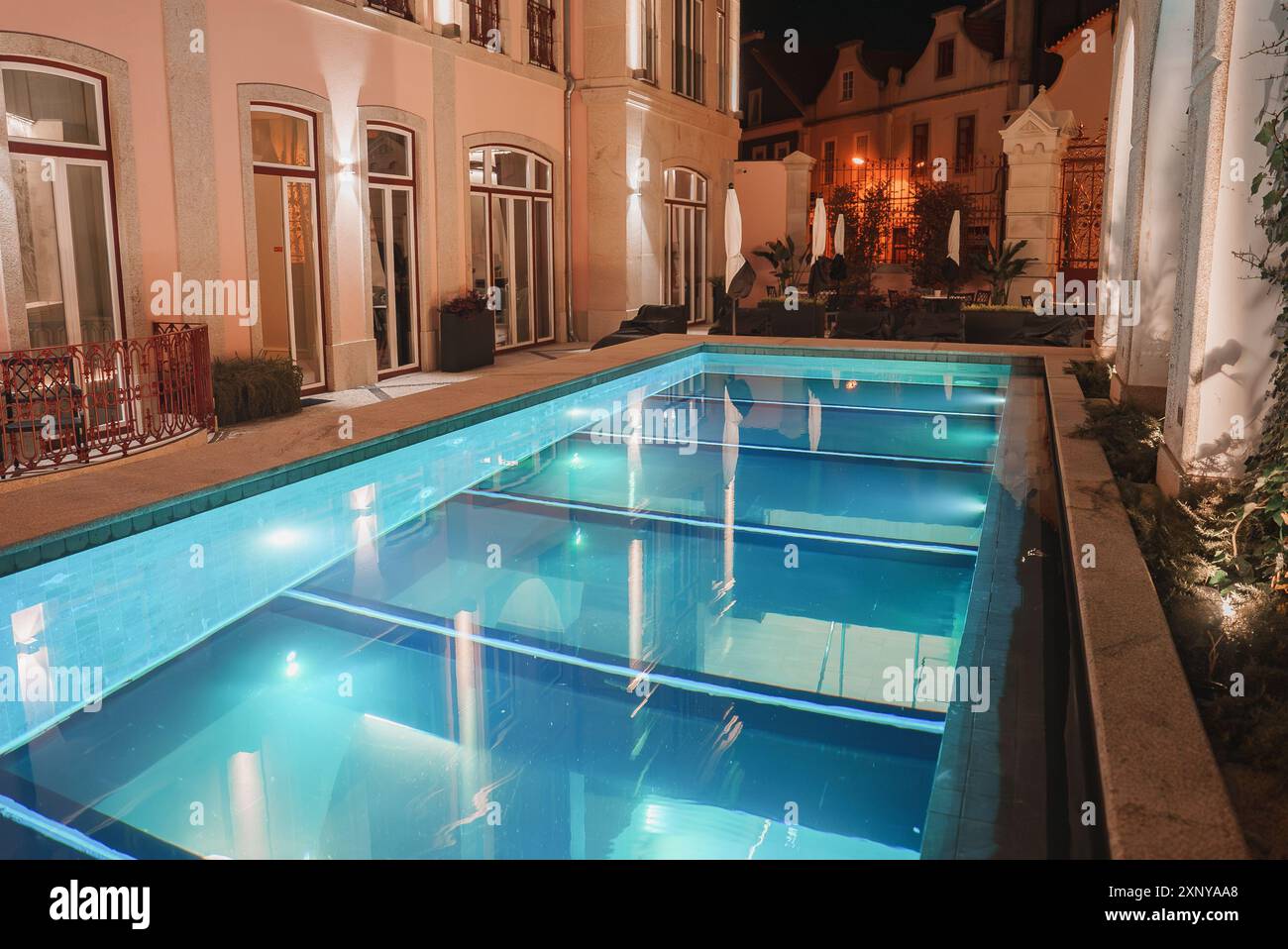 Luxurious Hotel Courtyard at Night with Illuminated Swimming Pool and ...