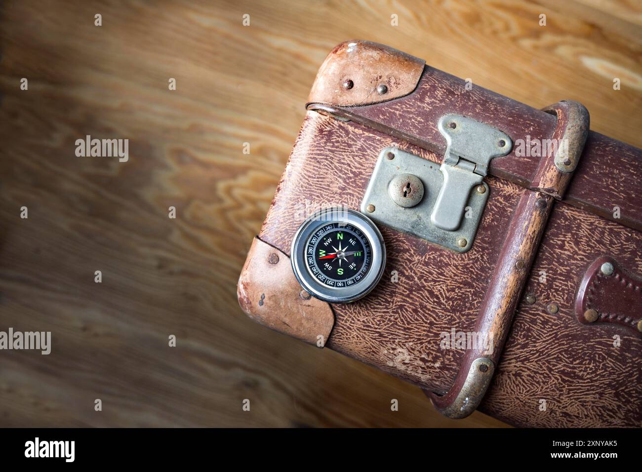 Old vintage suitcase with a compass seen from above, concept for travel ...