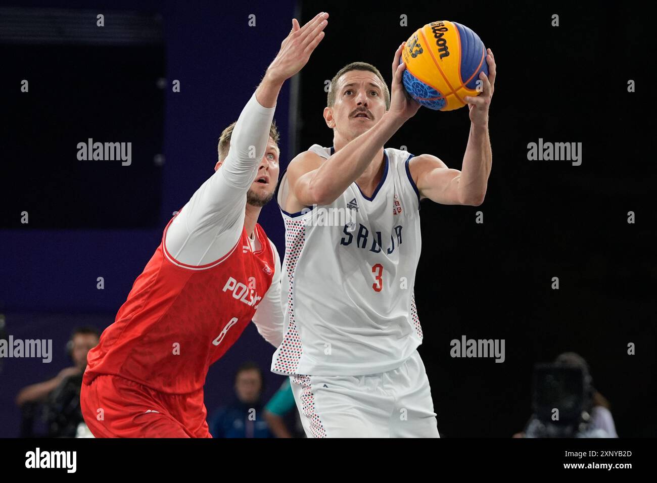 Serbia's Strahinja Stojacic (3) drives past Poland's Przemyslaw ...