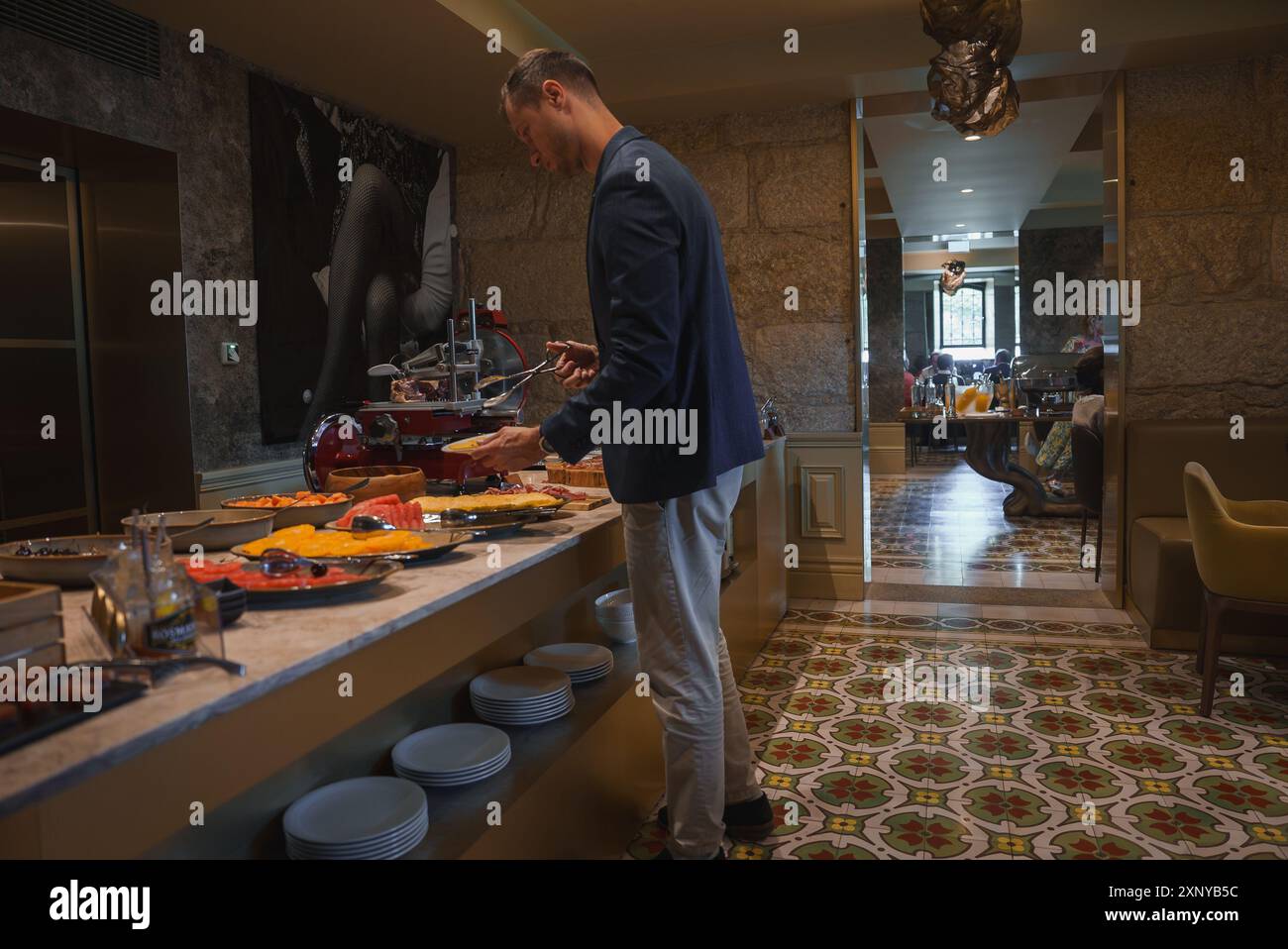 Man Serving Food at Buffet in Luxury Hotel with Elegant Interior Design ...