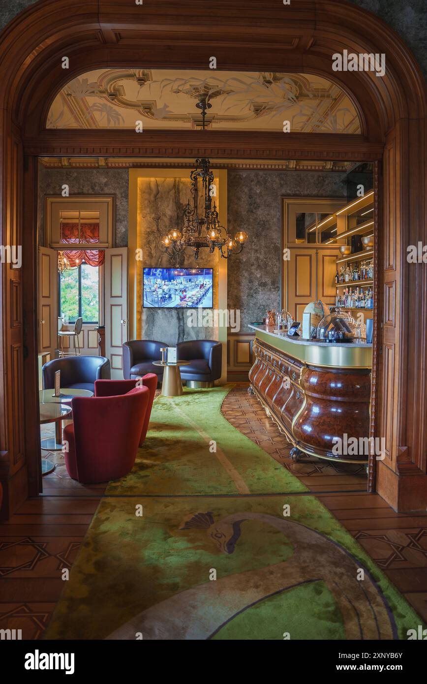 Luxurious Hotel Bar with Ornate Wooden Archway and Peacock Carpet ...