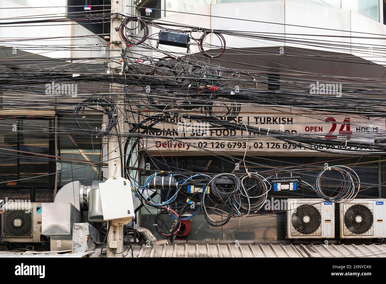 Power lines Cable clutter and air conditioning units Stock Photo - Alamy