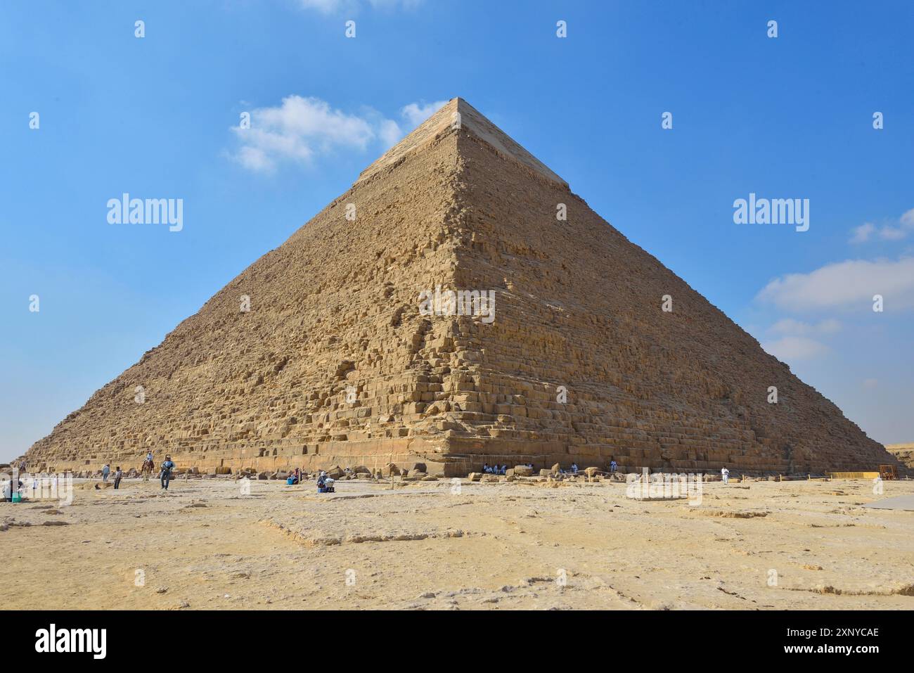 The Great Pyramid of Giza under a clear blue sky with a few scattered ...