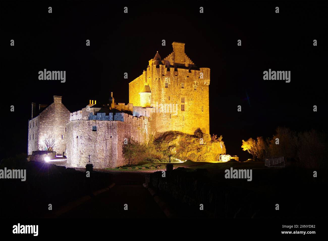 Impressive medieval castle illuminated at night, with festive ...