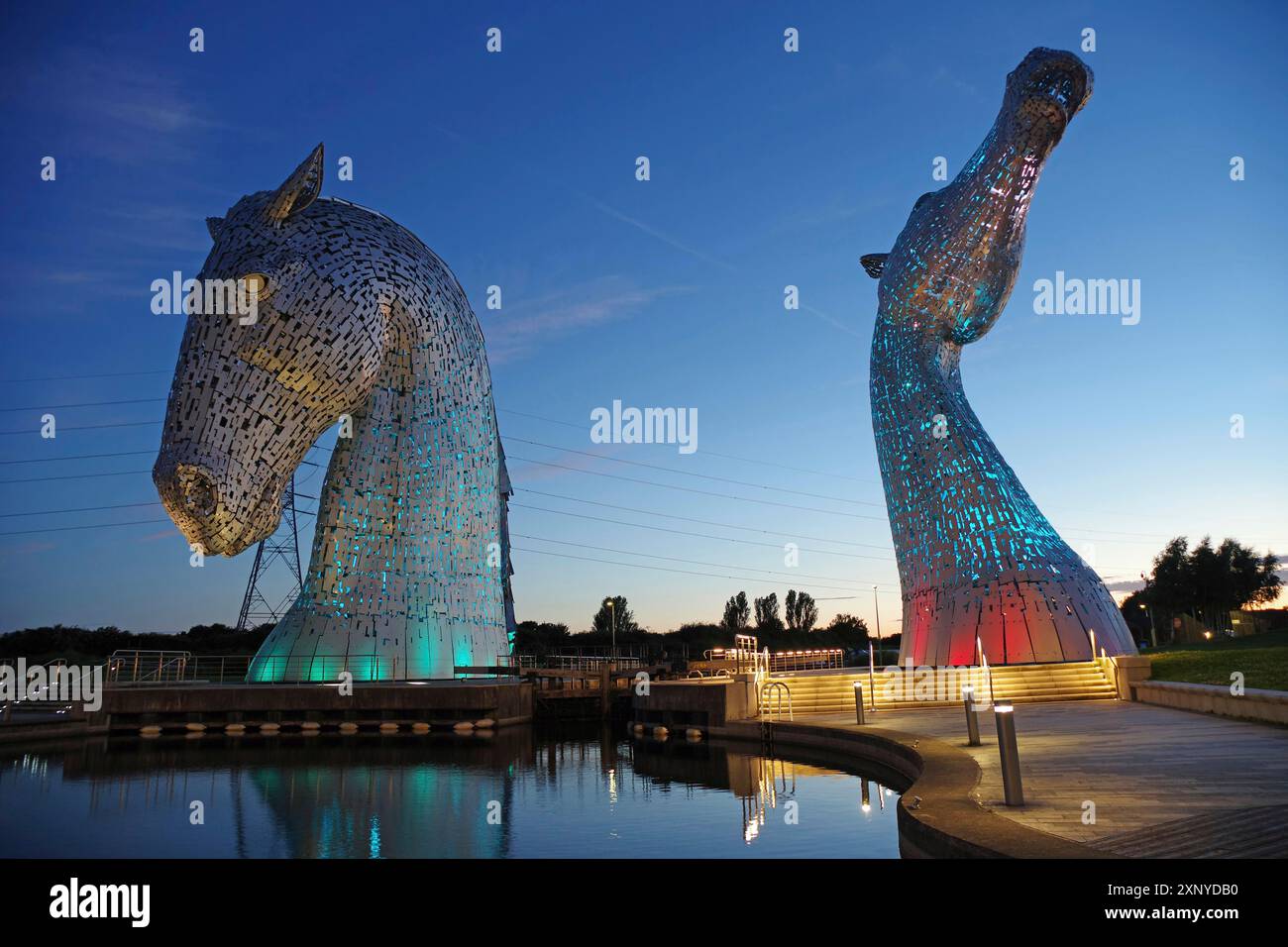 The Kelpies, two monumental horse sculptures, glow in bright colours at ...