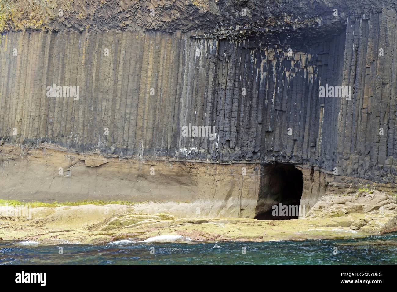 High basalt cliffs with a small cave on the coast, Hebrides Overture ...