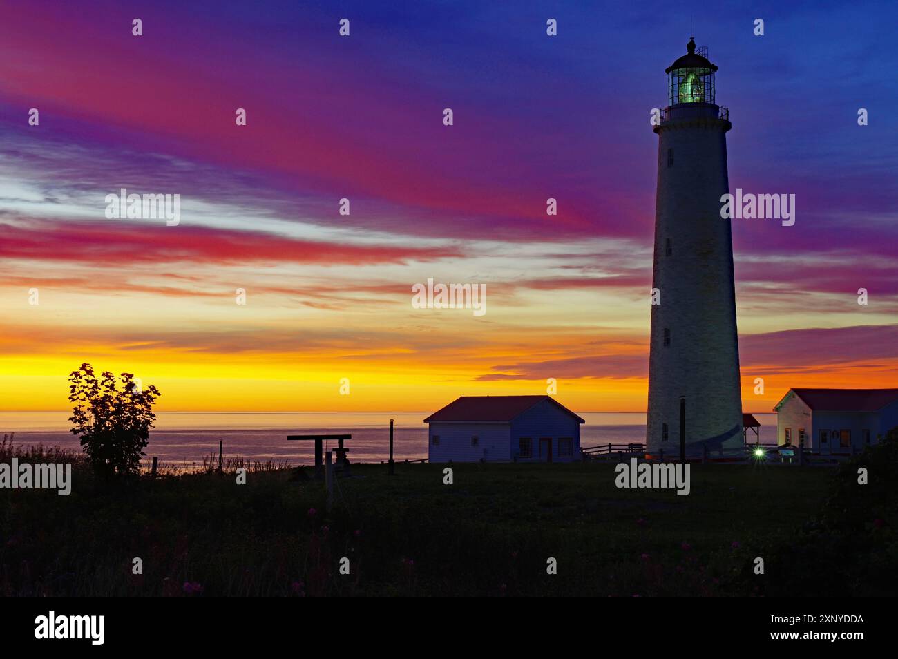 Lighthouse in a colourful sunset, St. Lawrence River, Gaspesie, Quebec ...