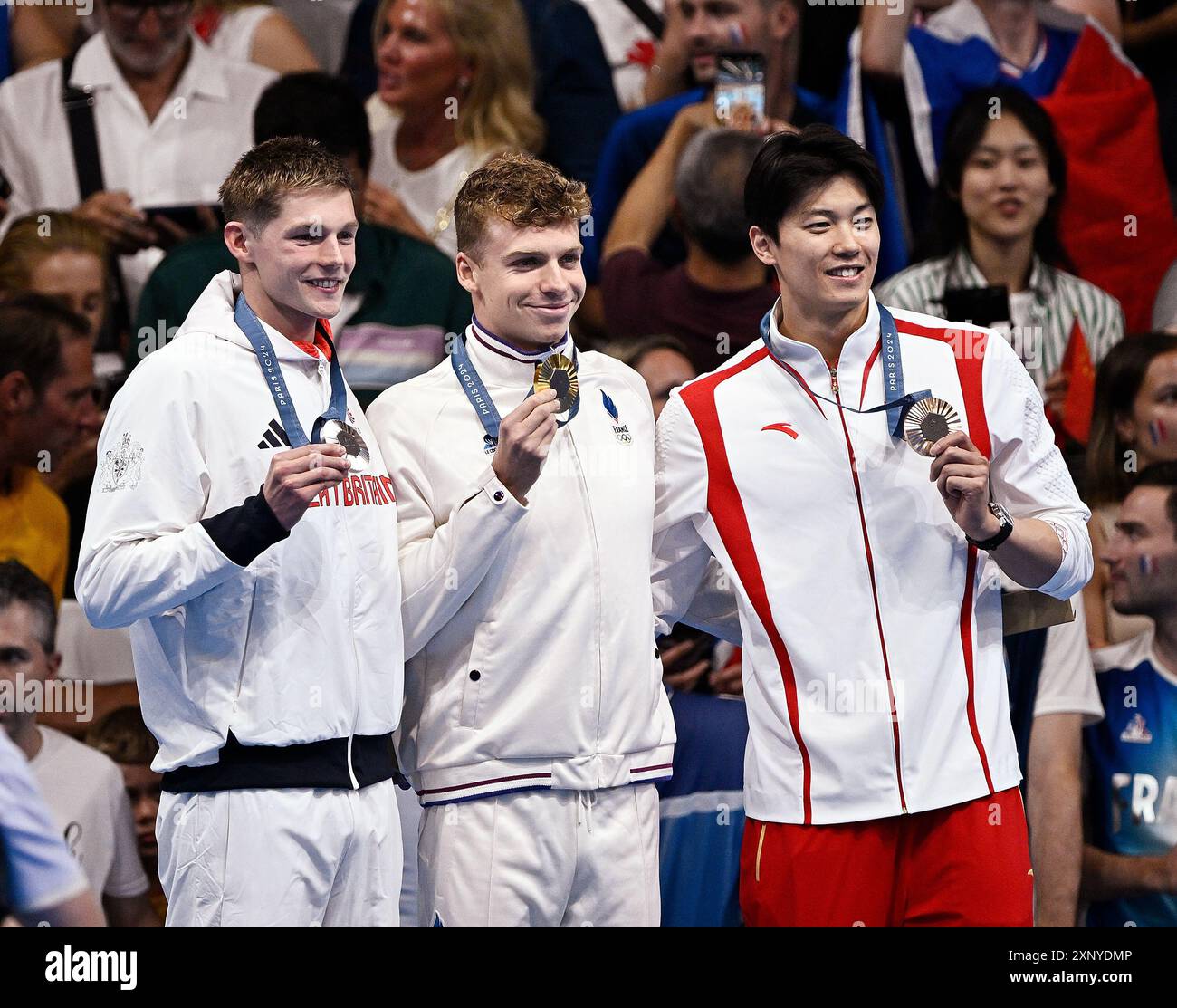 Paris, France. 2nd Aug, 2024. Gold medalist Leon Marchand (C) of France ...