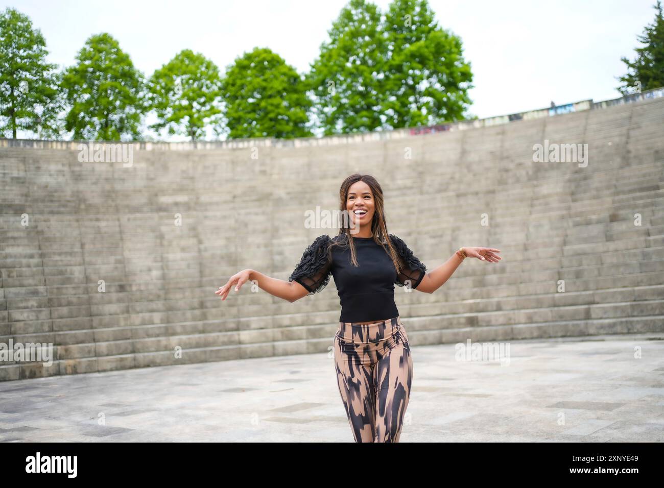 Horizontal photo with copy space of a happy hispanic woman dancing ...