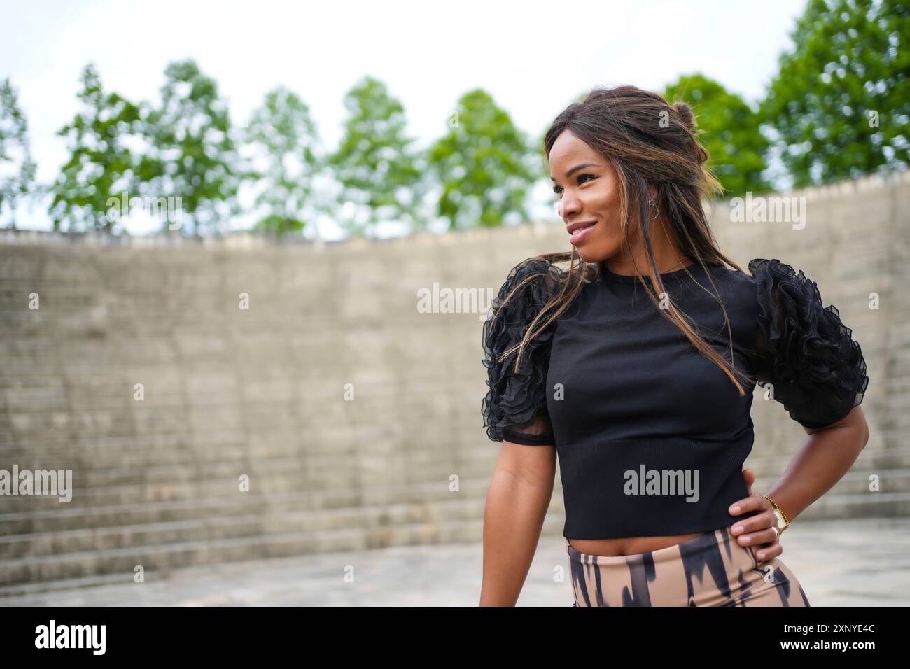 Side view of a cute brunette woman dancing cuban salsa alone outdoors ...