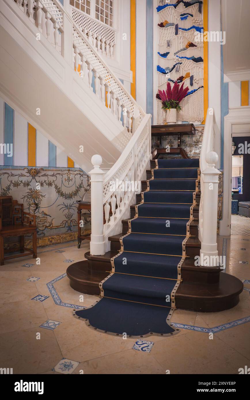 Luxurious Hotel Interior with Grand Staircase and Colorful Wall Art ...