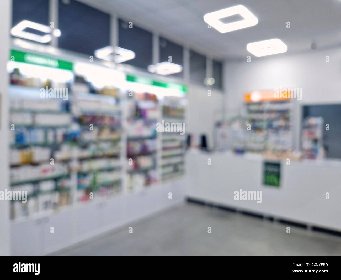 Blurred view inside a pharmacy with stocked shelves. Healthcare and ...