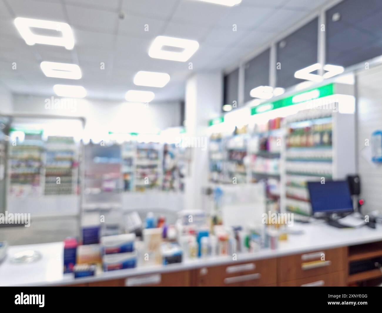 Defocused view inside of pharmacy with the seller counter, computer and ...