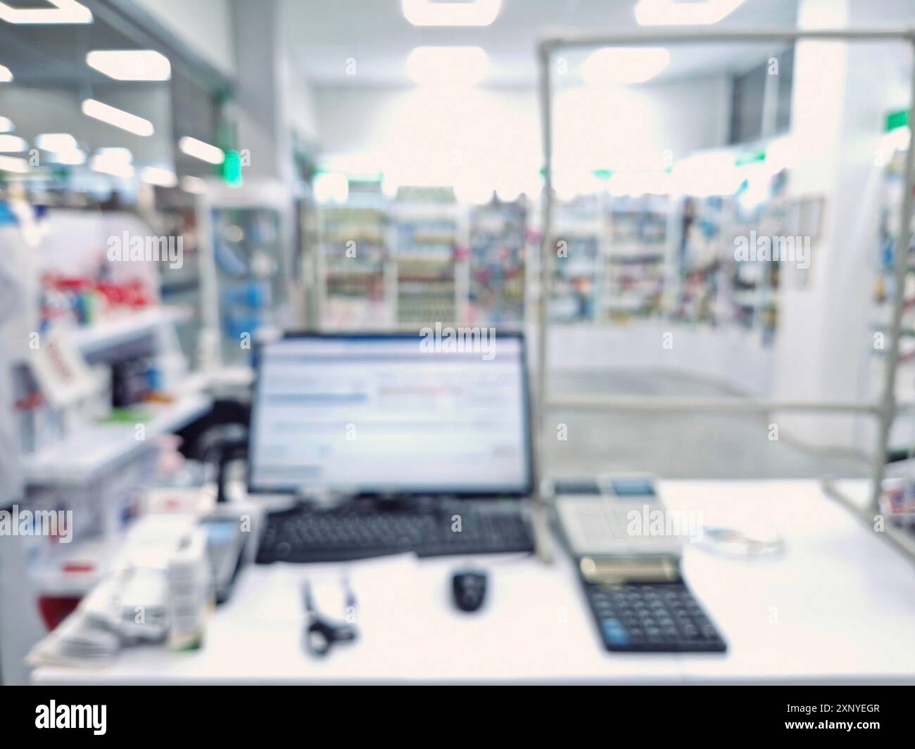 Defocused view inside of pharmacy with the seller counter, computer and ...