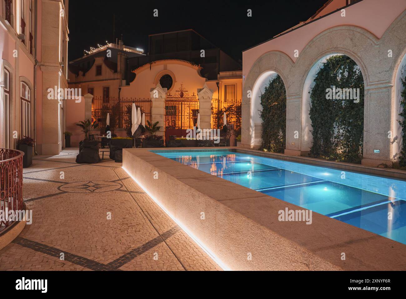 Luxurious Hotel Courtyard at Night with Illuminated Swimming Pool and ...