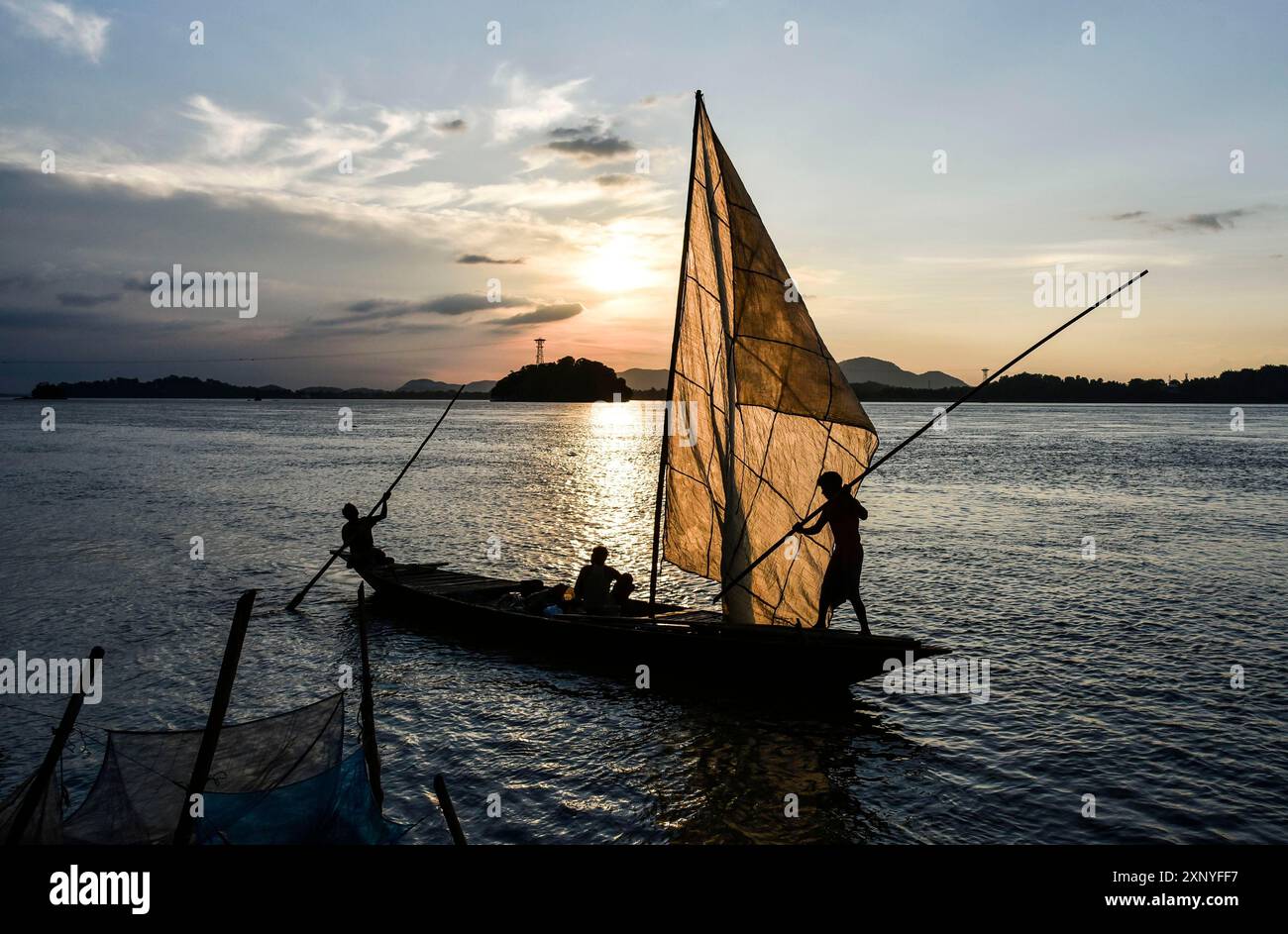 Fishermen paddle down the Brahmaputra River after fish in Guwahati ...