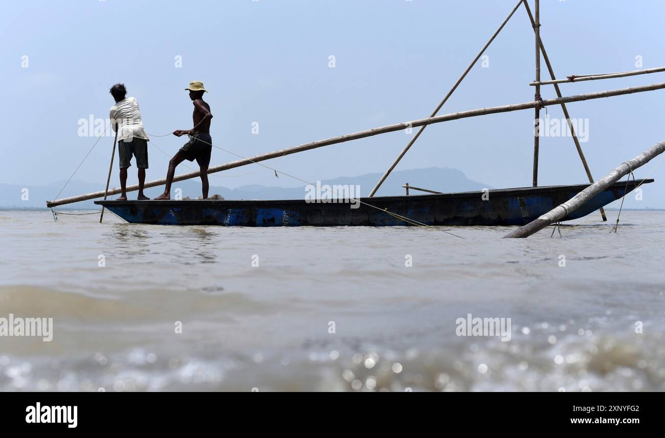 Fishermen installing a fishing net in a bamboo structure to fish in the ...