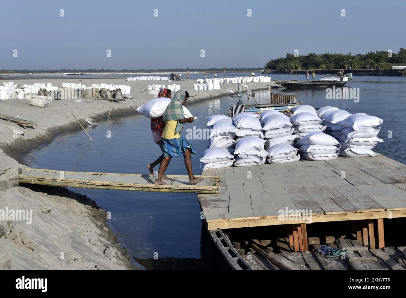 Public Works Department (PWD) of Assam labourer carrying sand bag to ...