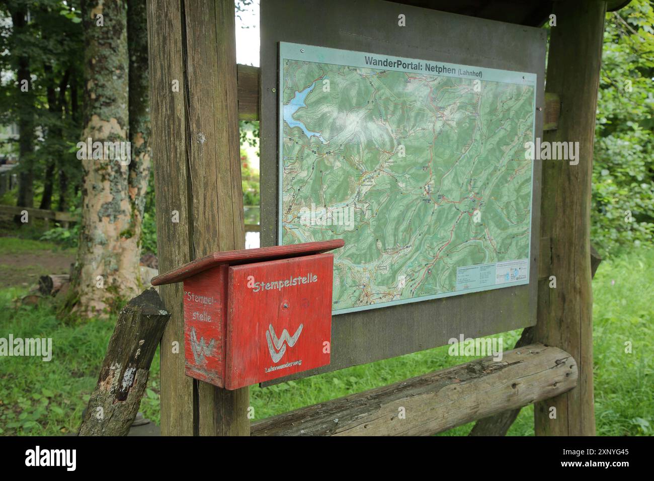 Red stamp with hiking sign on the Lahnwanderweg trail at the source of ...