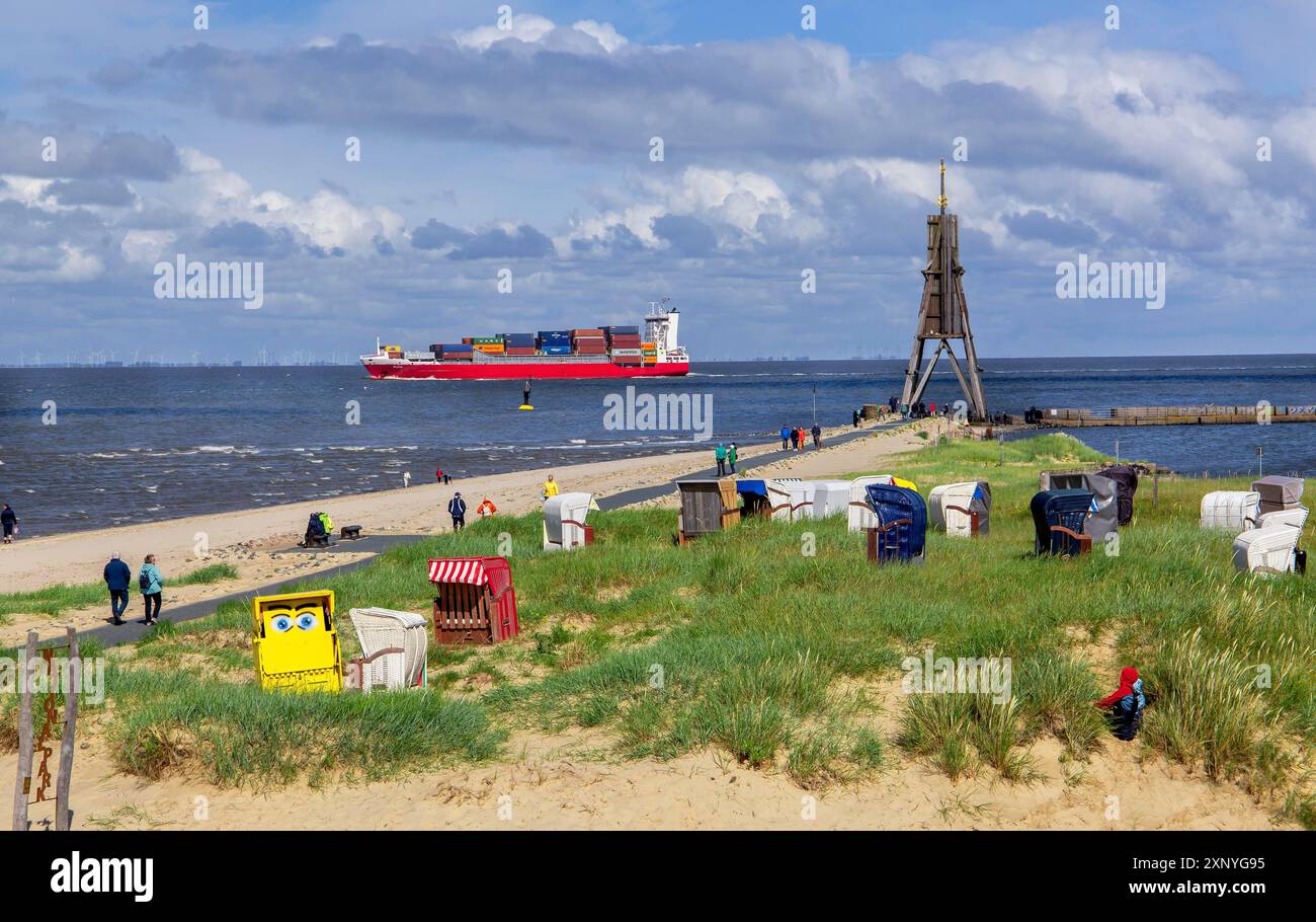 Beach promenade with landmark Kugelbake and container ship in the ...