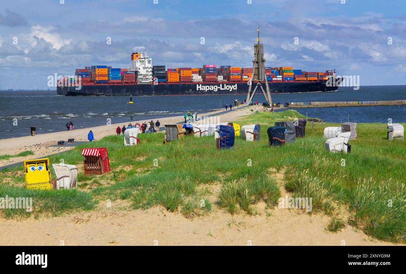 Beach promenade with landmark Kugelbake and container ship in the ...