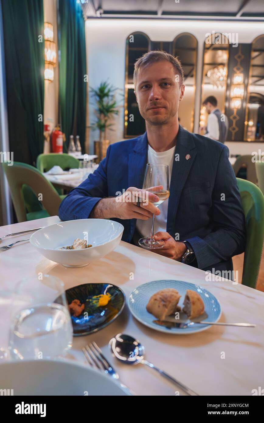 Man Enjoying Gourmet Dining in Luxurious Hotel Restaurant with Elegant ...