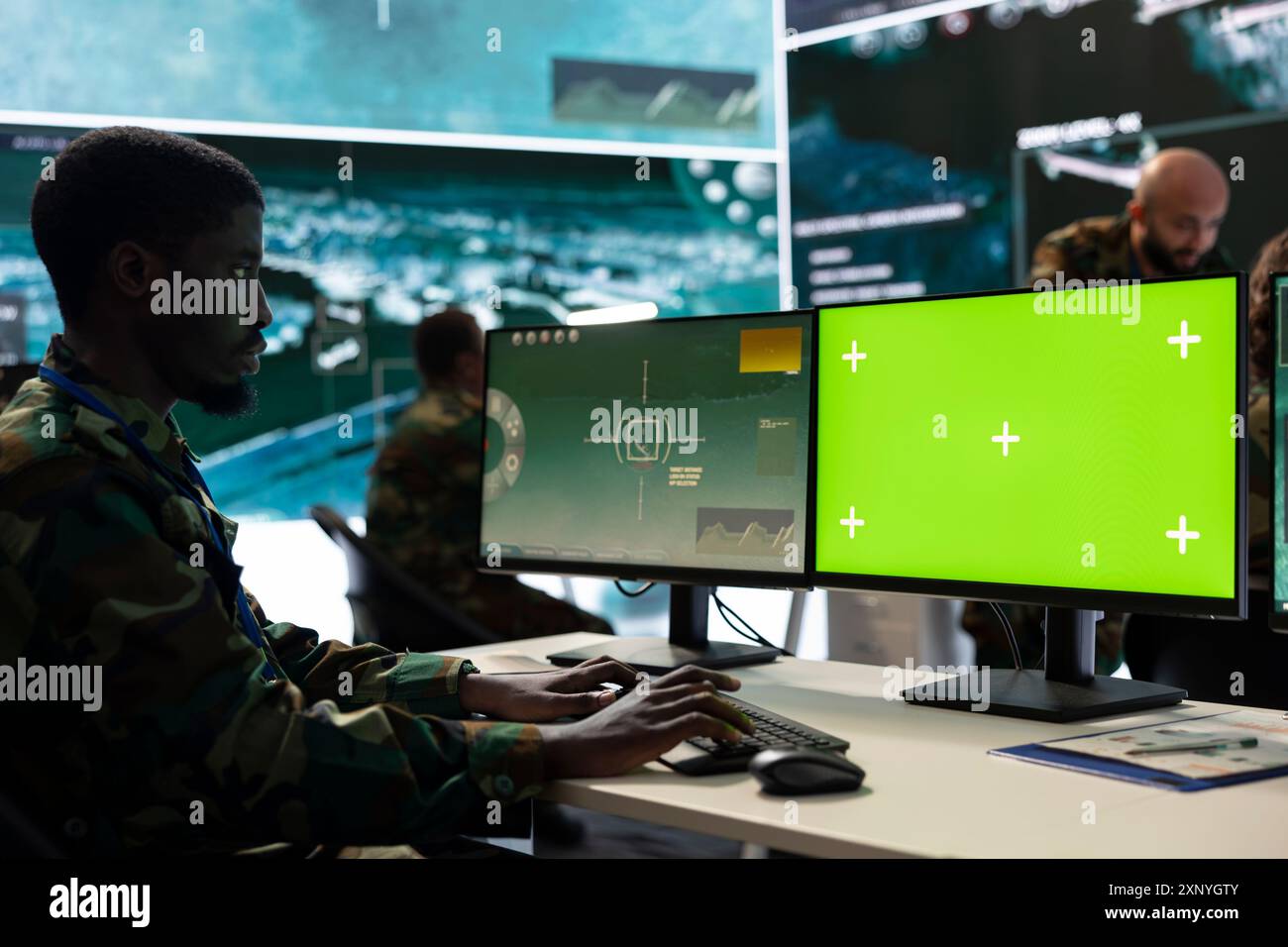 Army conscript uses green screen and radar surveillance imagery in military headquarters ...