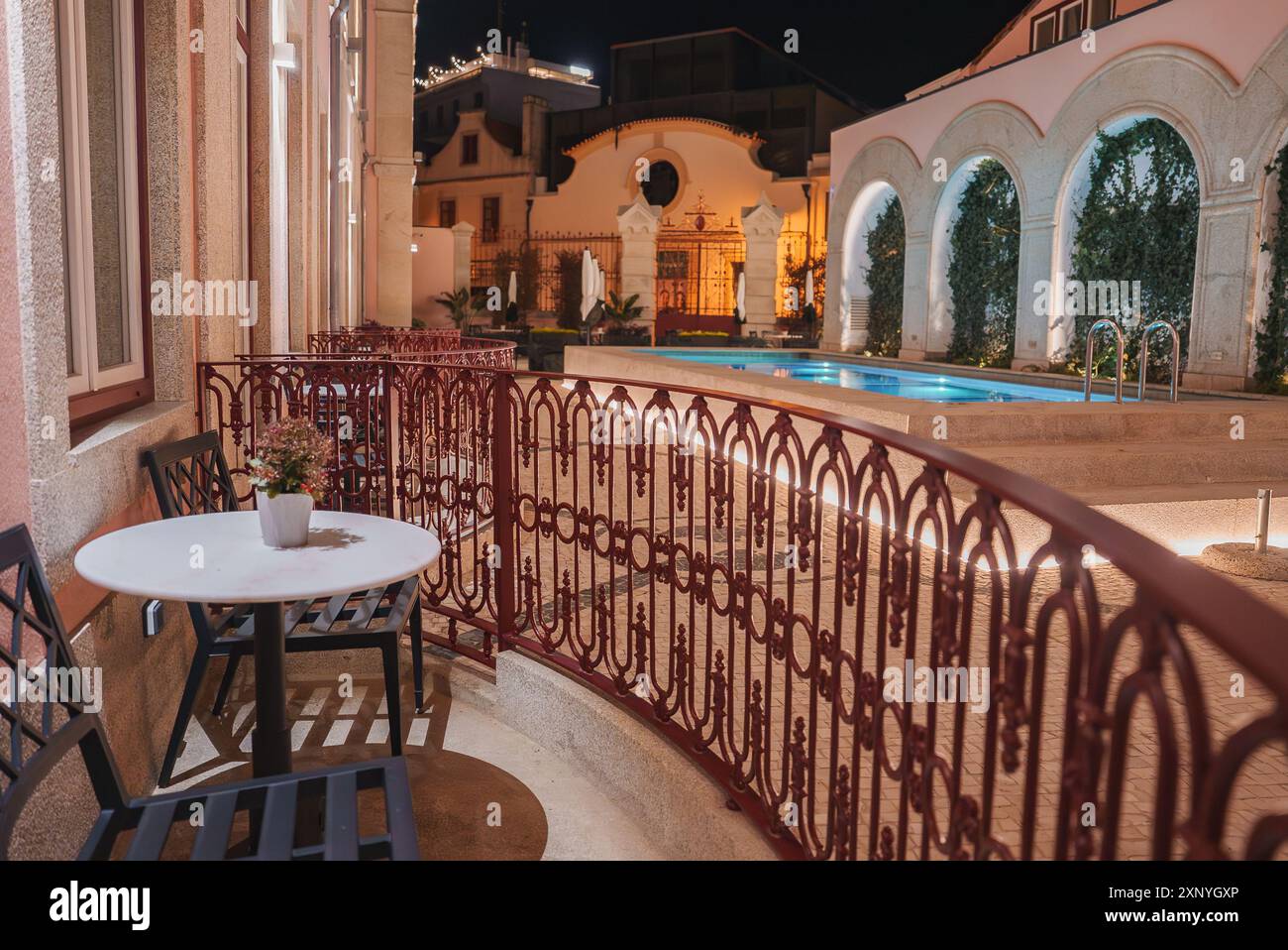 Luxurious Hotel Courtyard at Night with Ornate Balcony and Pool Stock ...