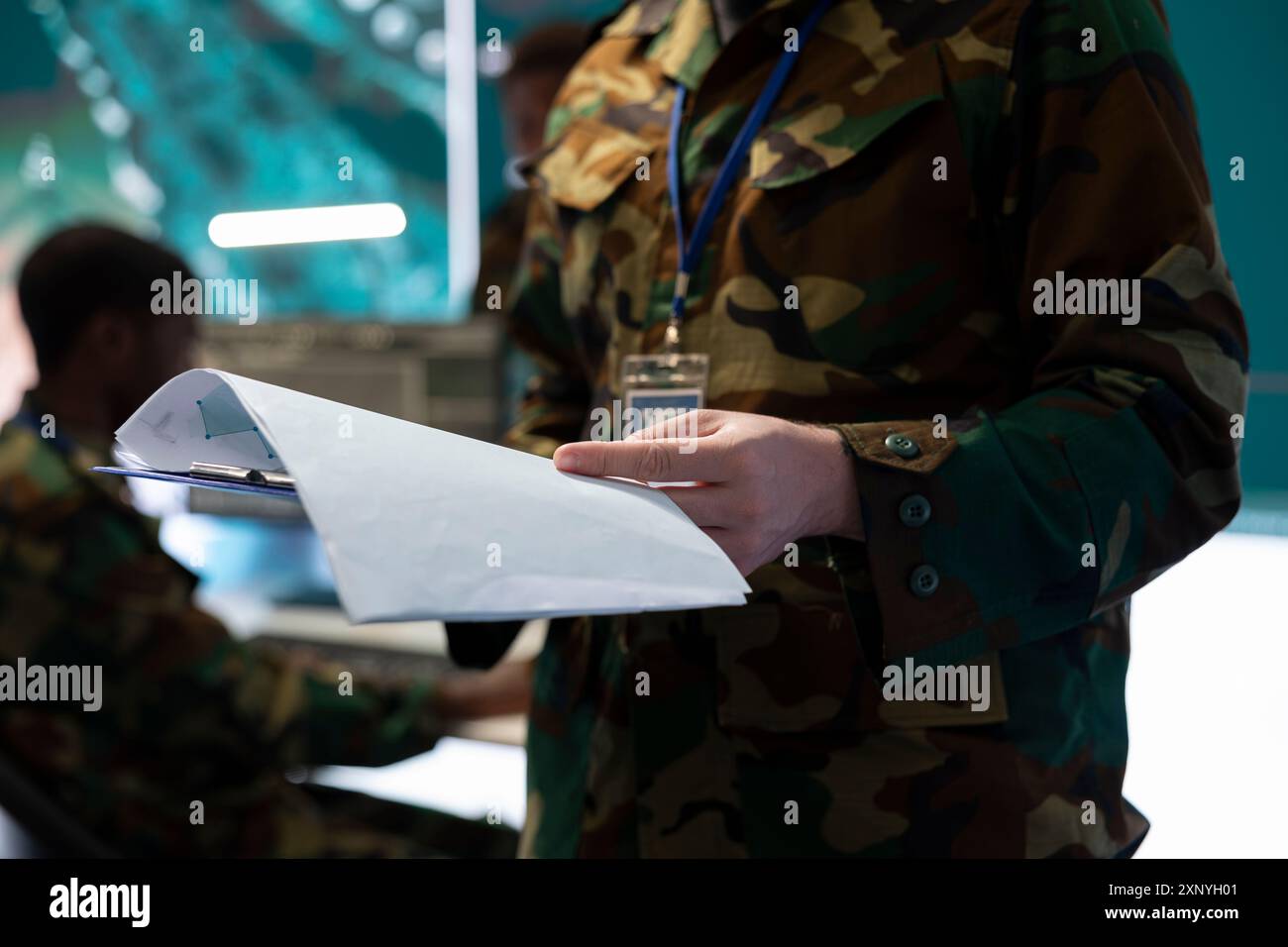 Trooper reading federal case file for a new defense operation, studying ...
