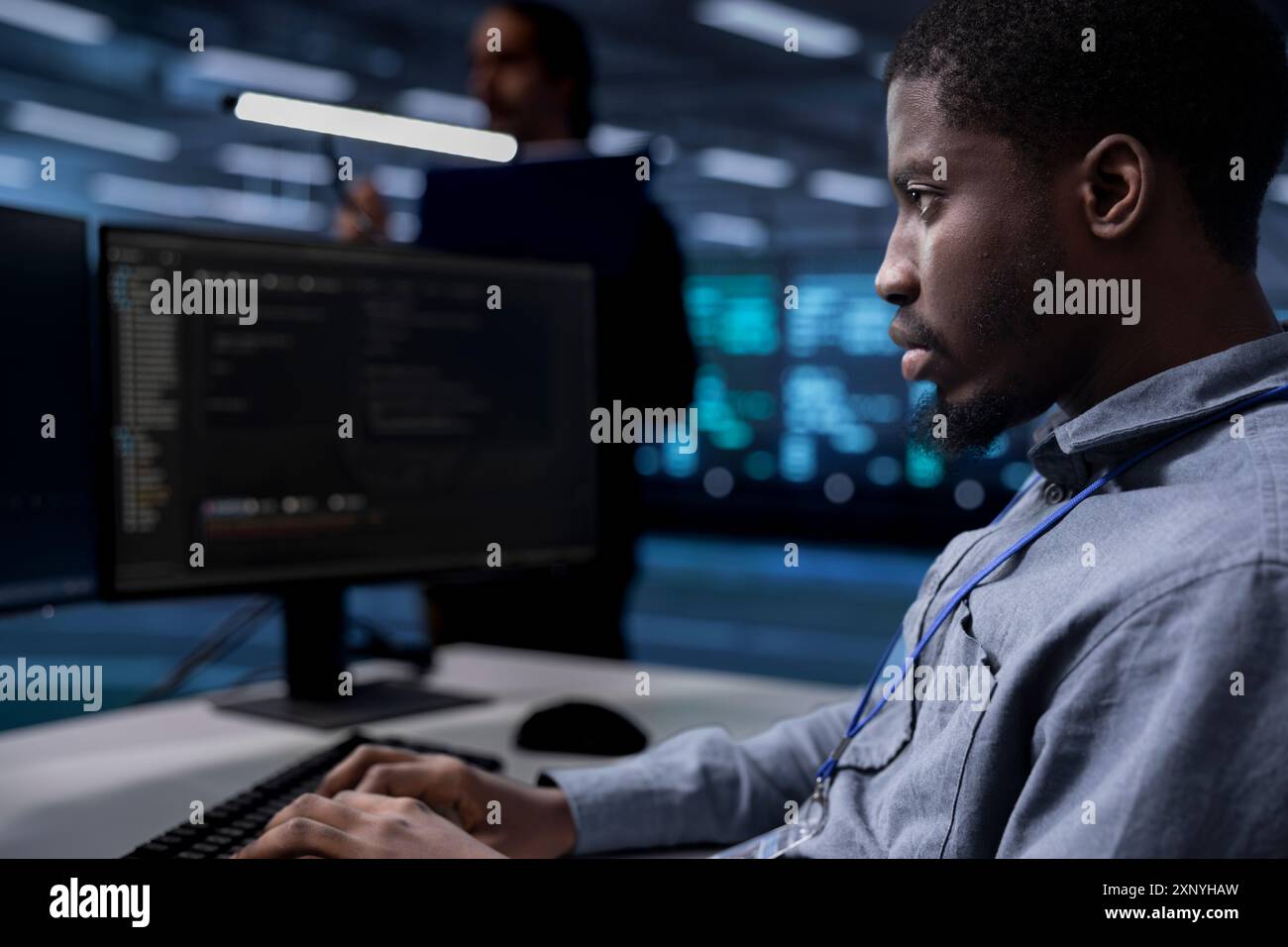 Computer scientist reconfiguring server room to optimize it for data processing requirements of ...