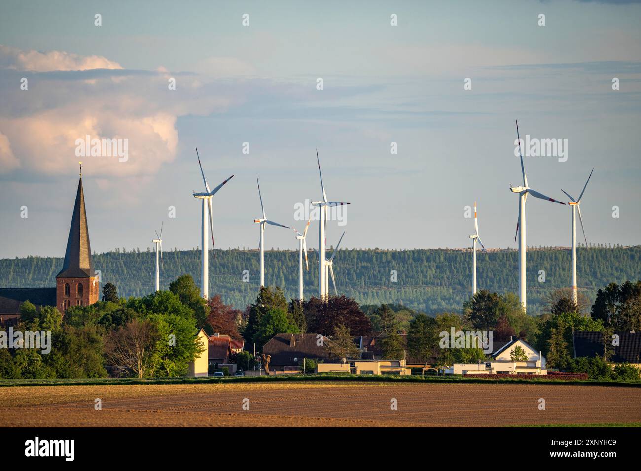 Wind farm in Kirchherten, St Martinus Catholic parish church, in the ...