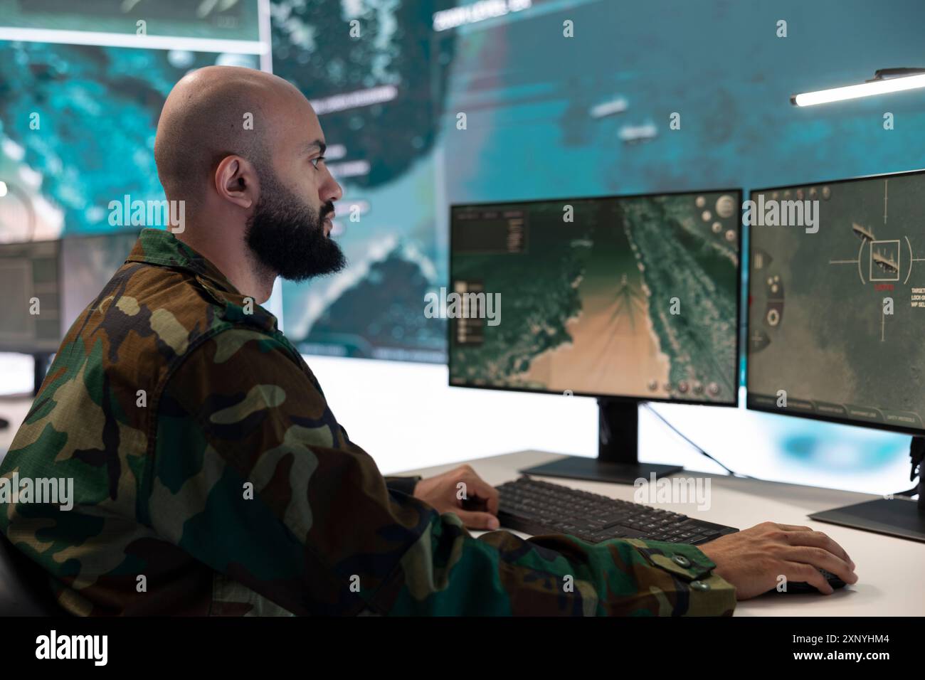 Infantry unit officer examines big data on pc in military control room ...