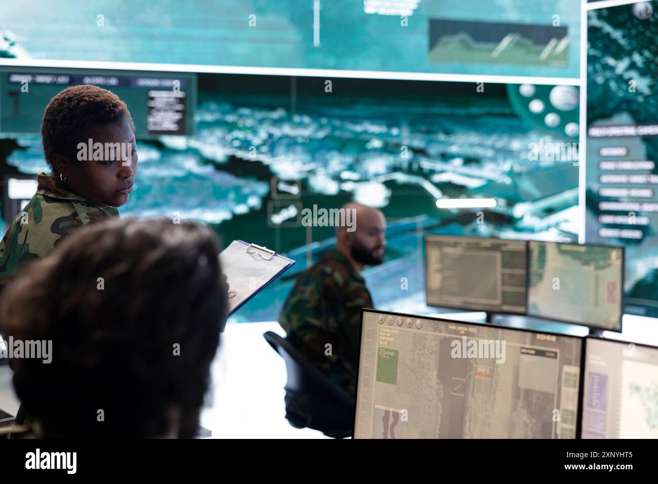 Female trooper checking real time battlefield data in command post ...