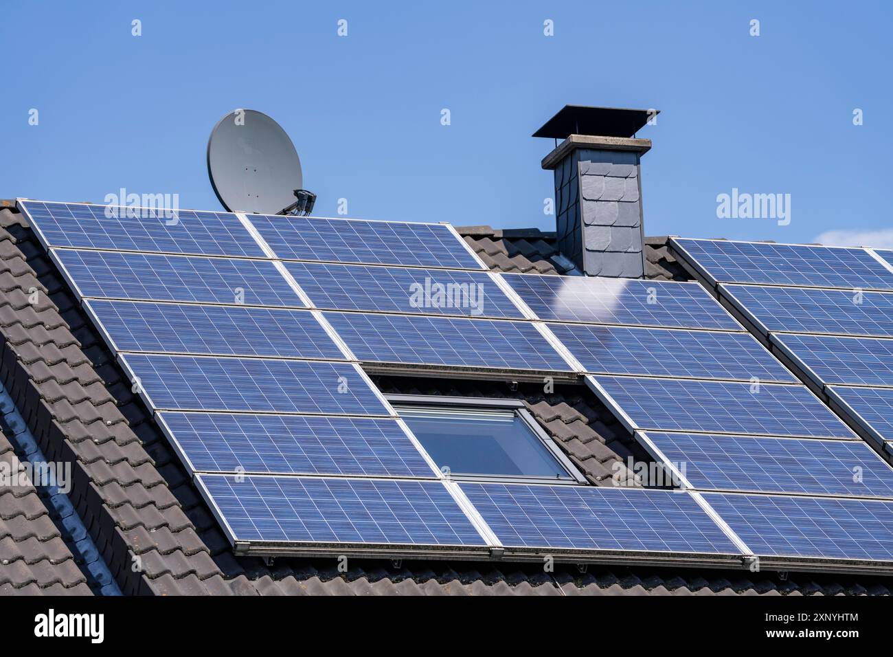 Solar system on the pitched roof of a residential building, photovoltaics for power generation ...