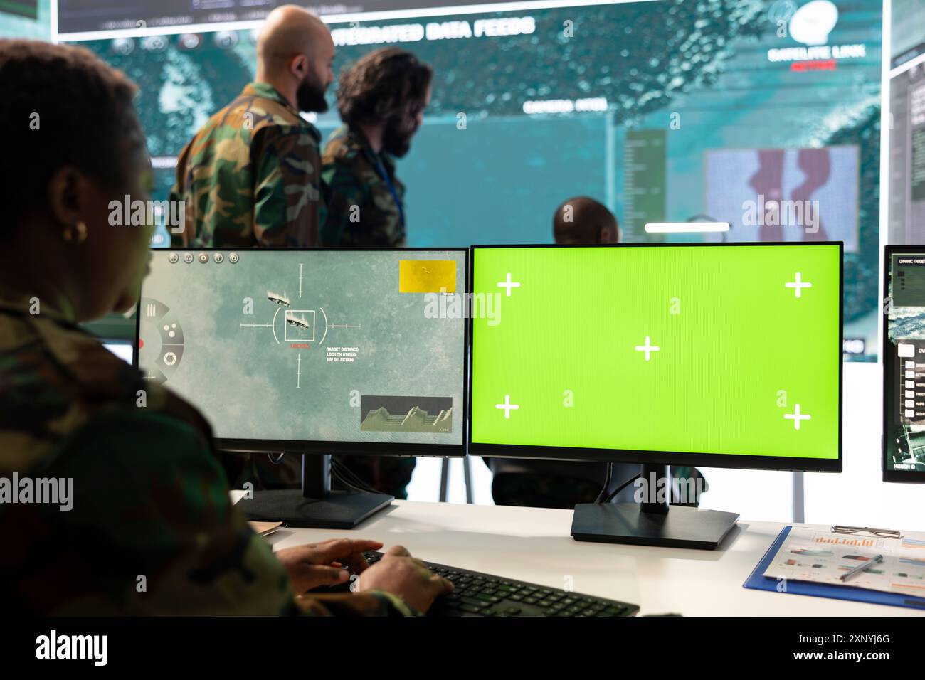 Woman engineer examining reconnaissance footage and chroma key display ...