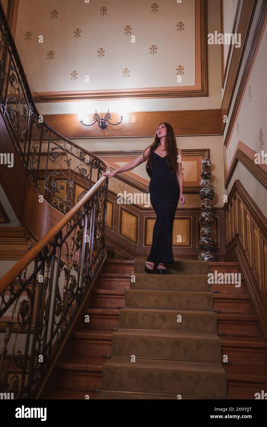 Elegant Woman Descending Grand Staircase in Luxurious Hotel Interior Stock Photo - Alamy