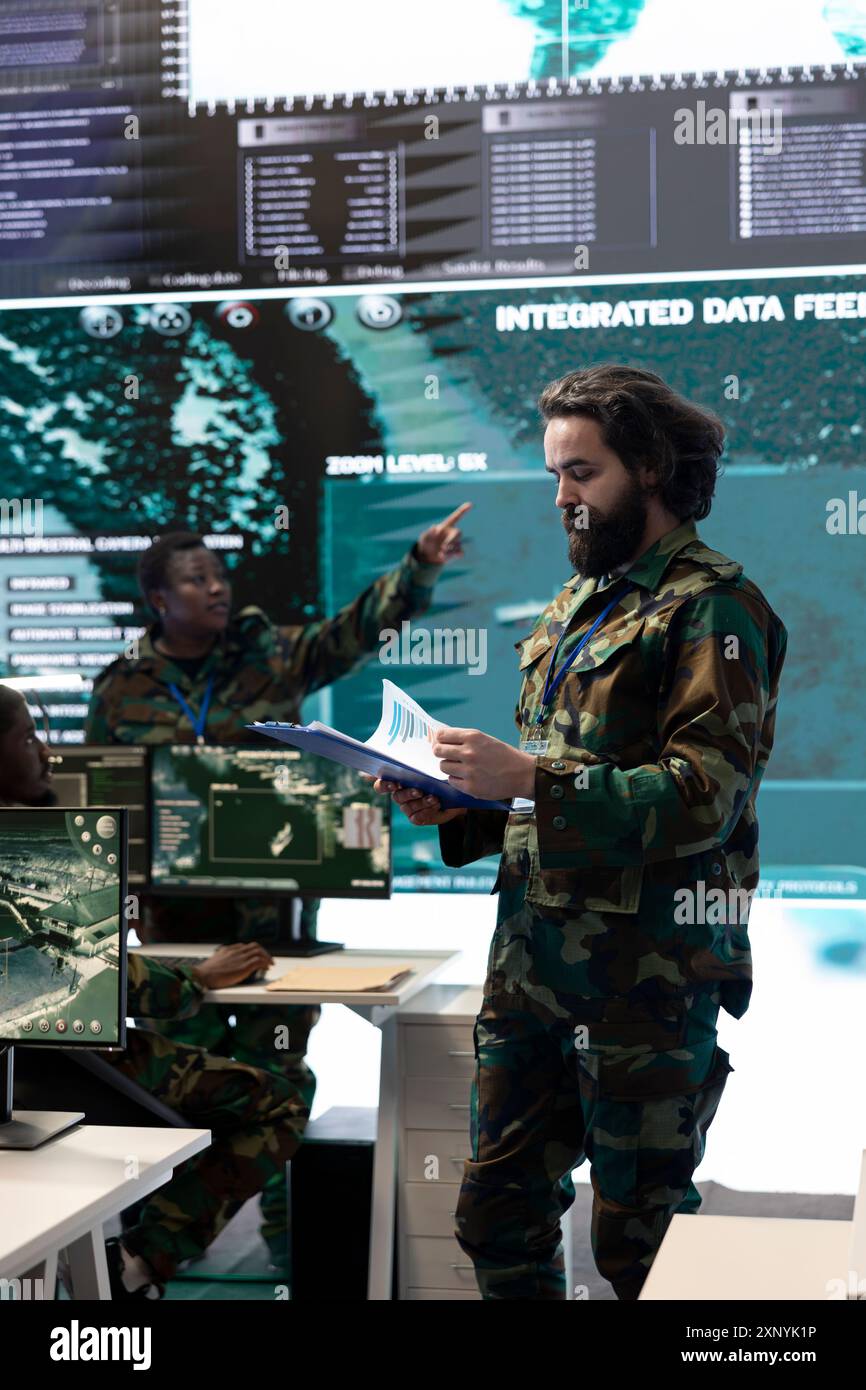 Special operations engineer analyzing mission case files before ...