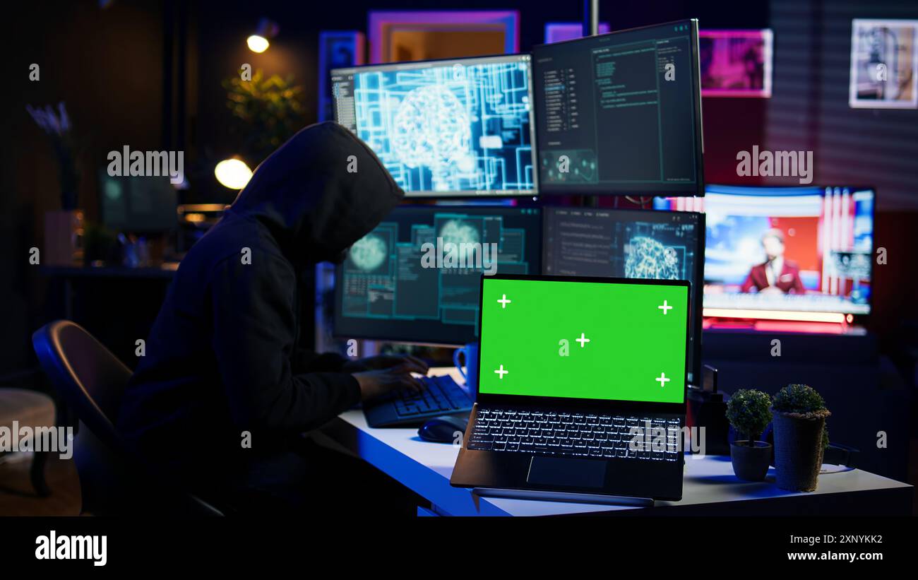Hacker in hidden place using green screen laptop to deploy malware on ...