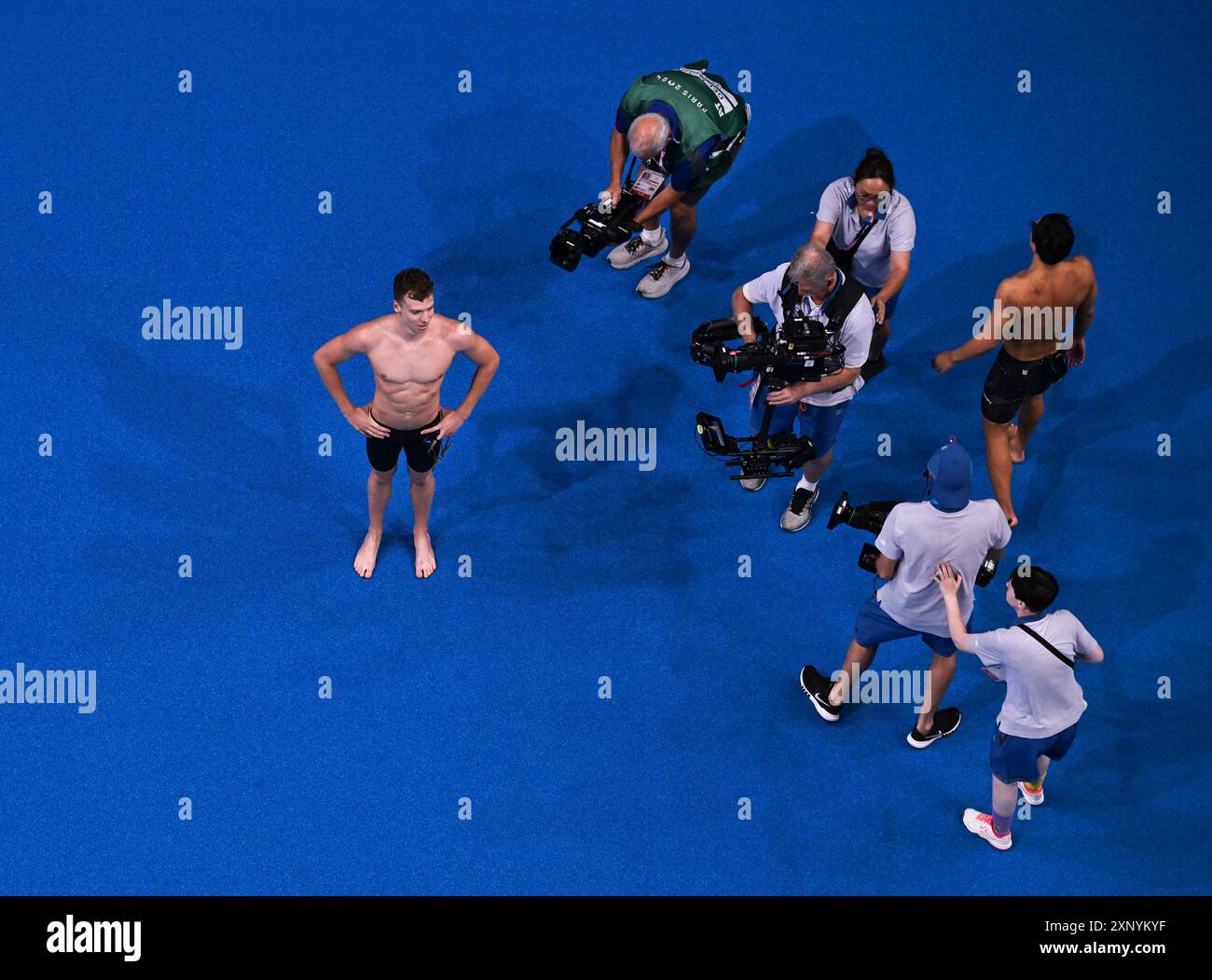 Paris, France. 2nd Aug, 2024. Leon Marchand (L) of France reacts after ...