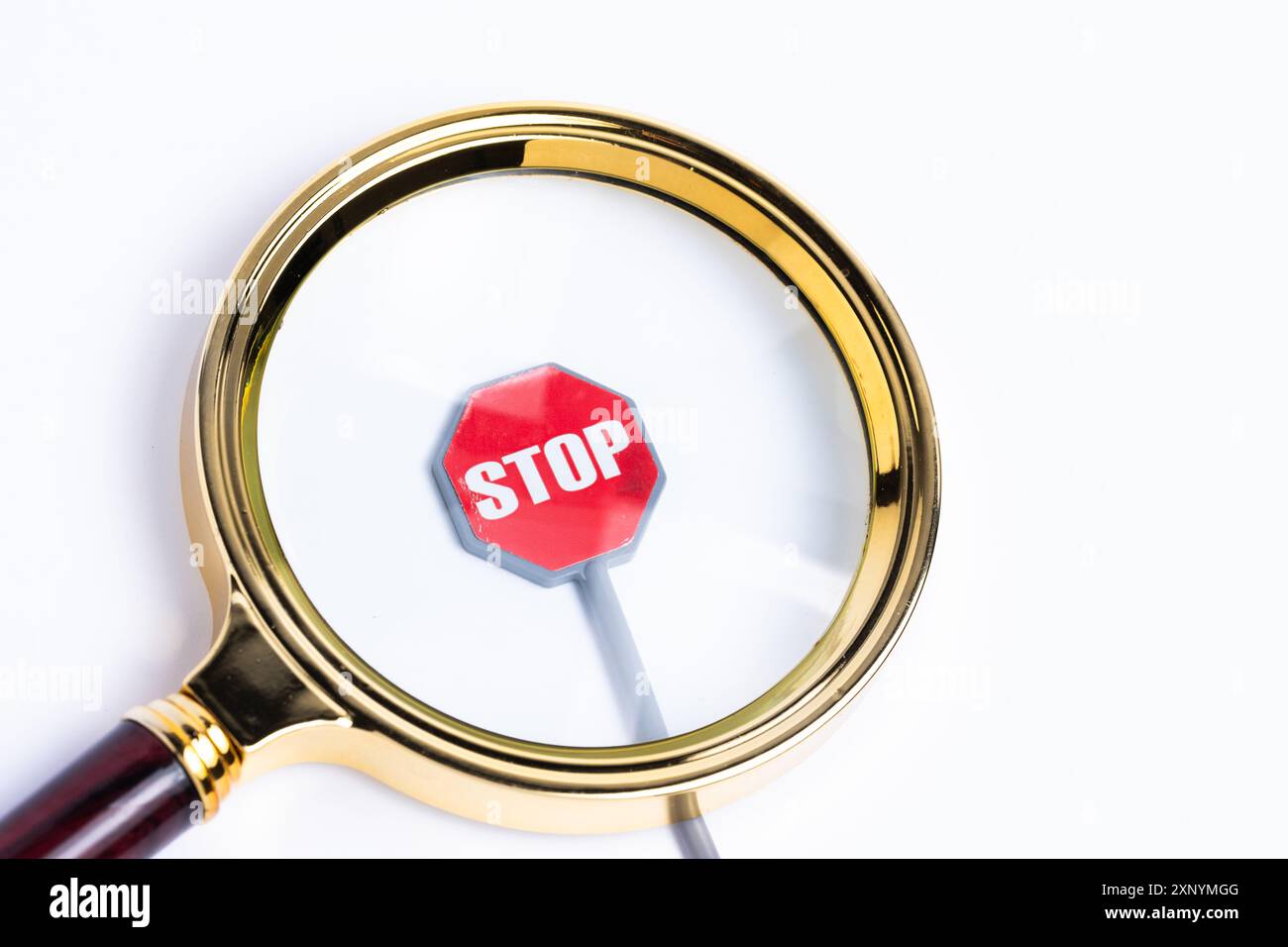 Magnifying glass with stop sign isolated on white background. Concept ...