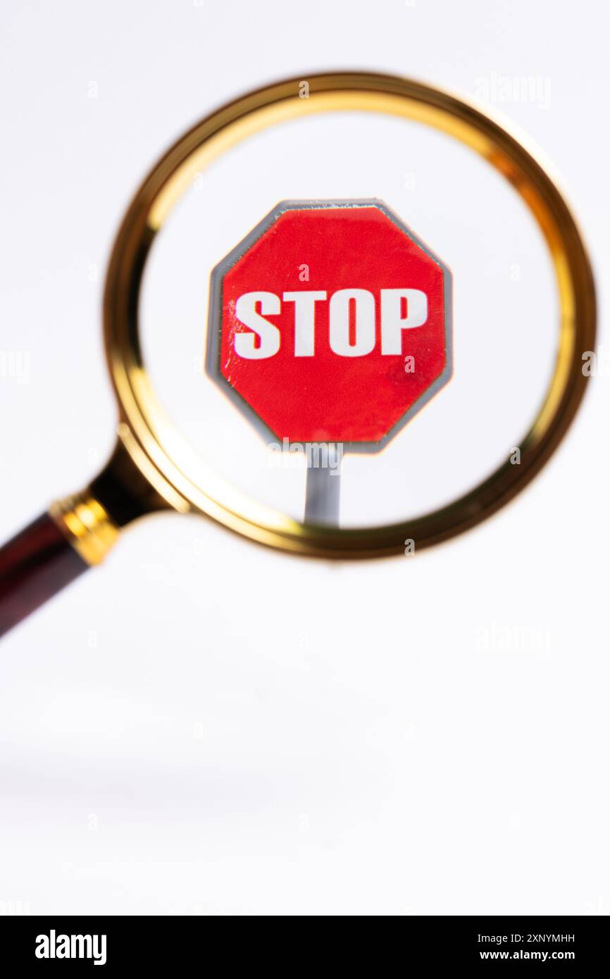 Stop sign with magnifying glass on white background. Concept, warnings ...