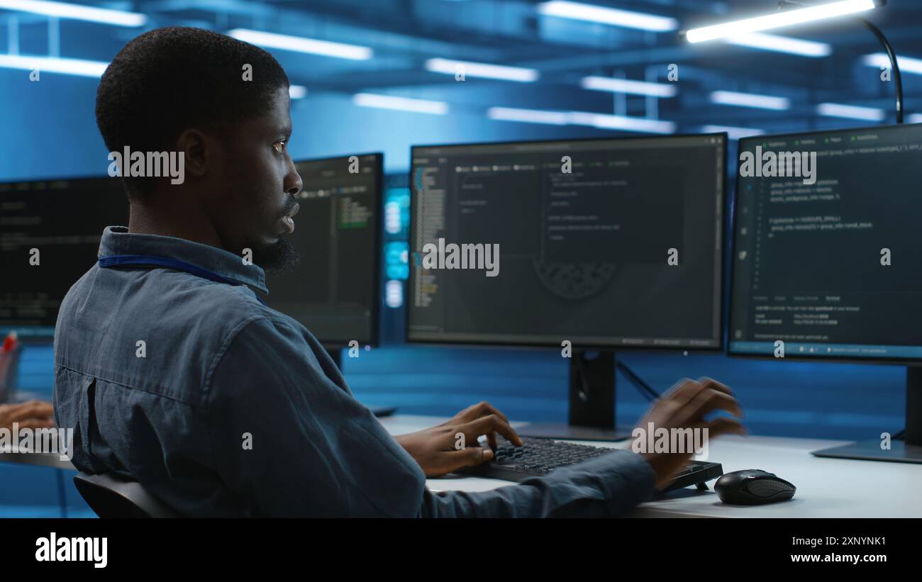 IT specialist in server farm ensuring valuable data remains shielded from potential threats ...