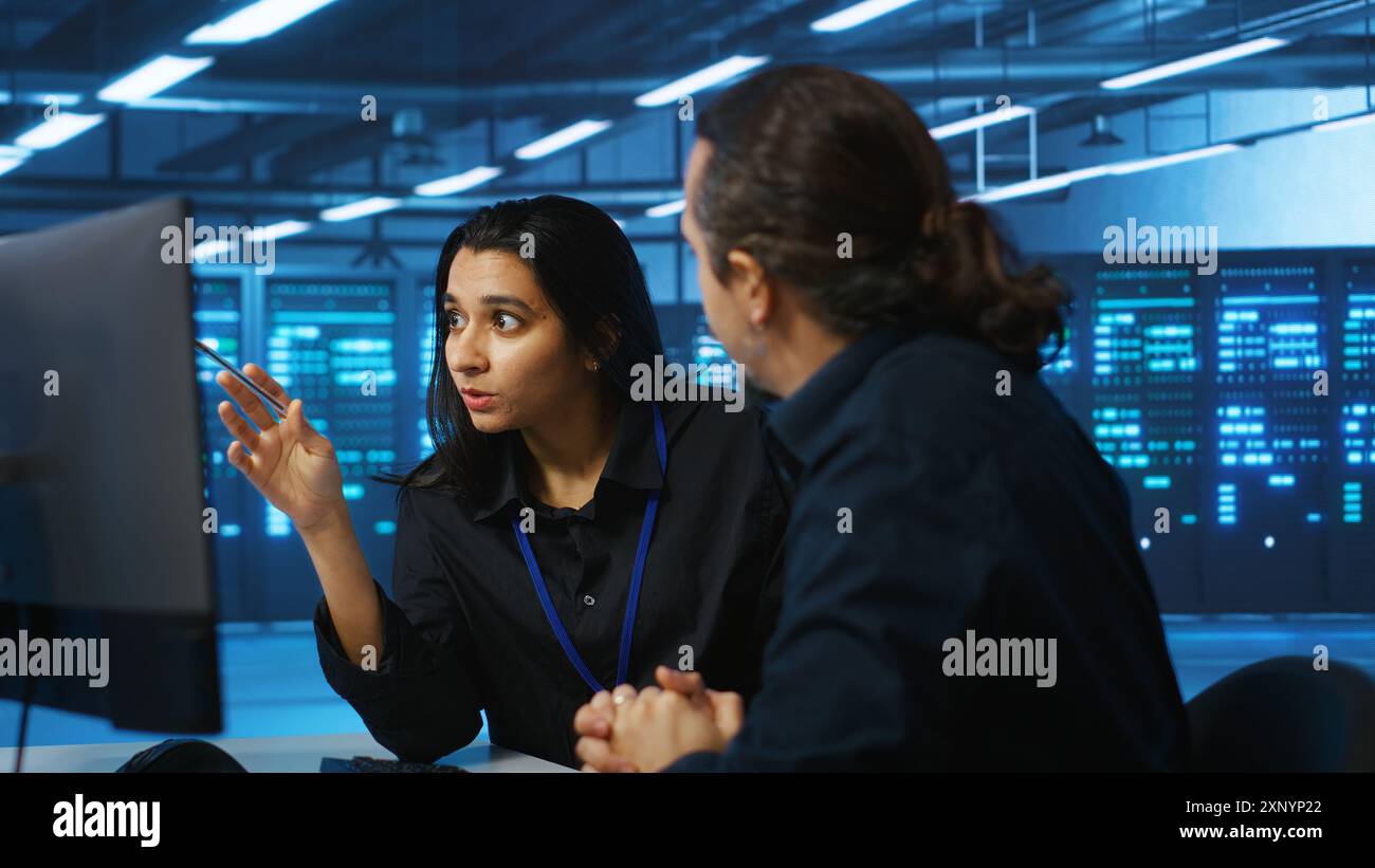 Programmers Talking In High Tech Server Hub Using Pcs To Analyze Data