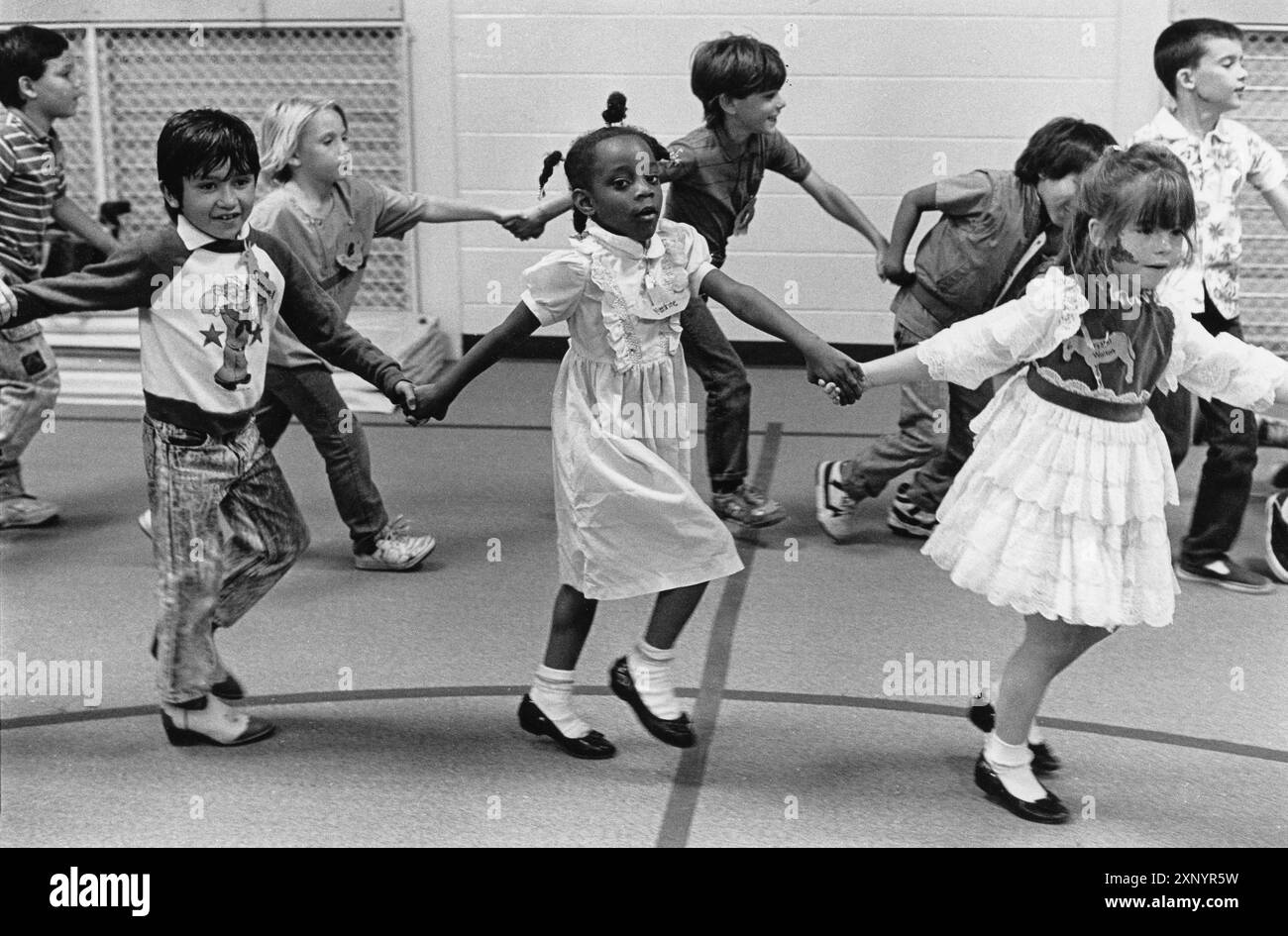 Austin Texas USA, 1990: Kindergarteners hold hands while dancing in ...