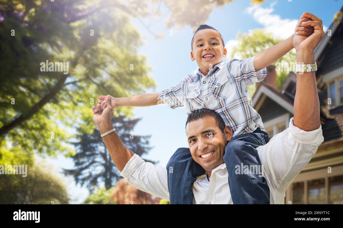 Happy Father and Son Riding Piggyback In Front Yard of Their House ...