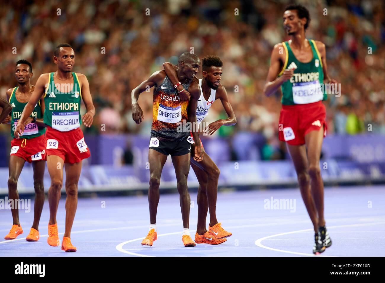 Joshua Cheptegei of Team Uganda and Mohammed Ahmed of Team Canada ...